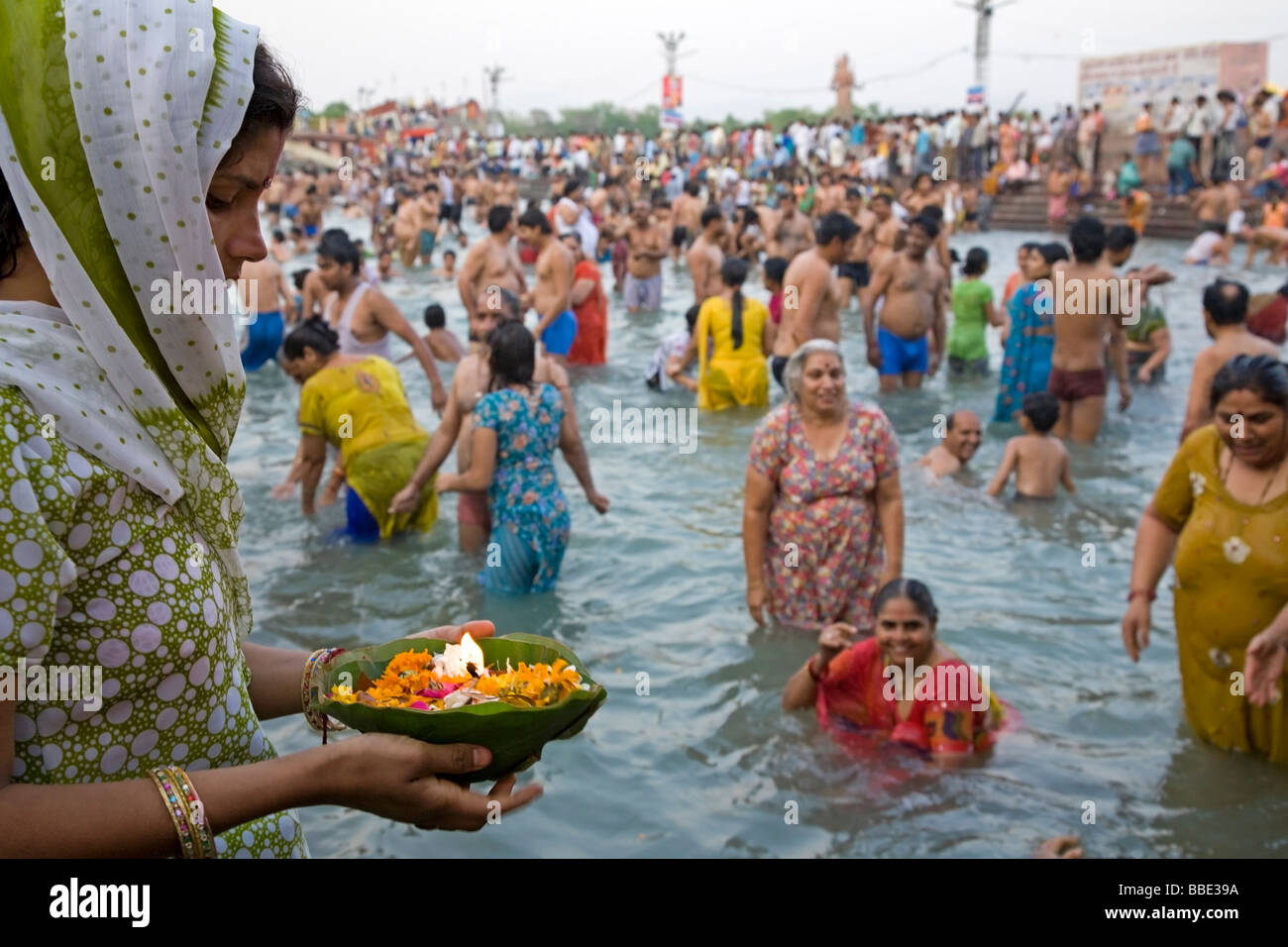 Indian woman offering a deepak (floating flowers and oil lamp) to the ...