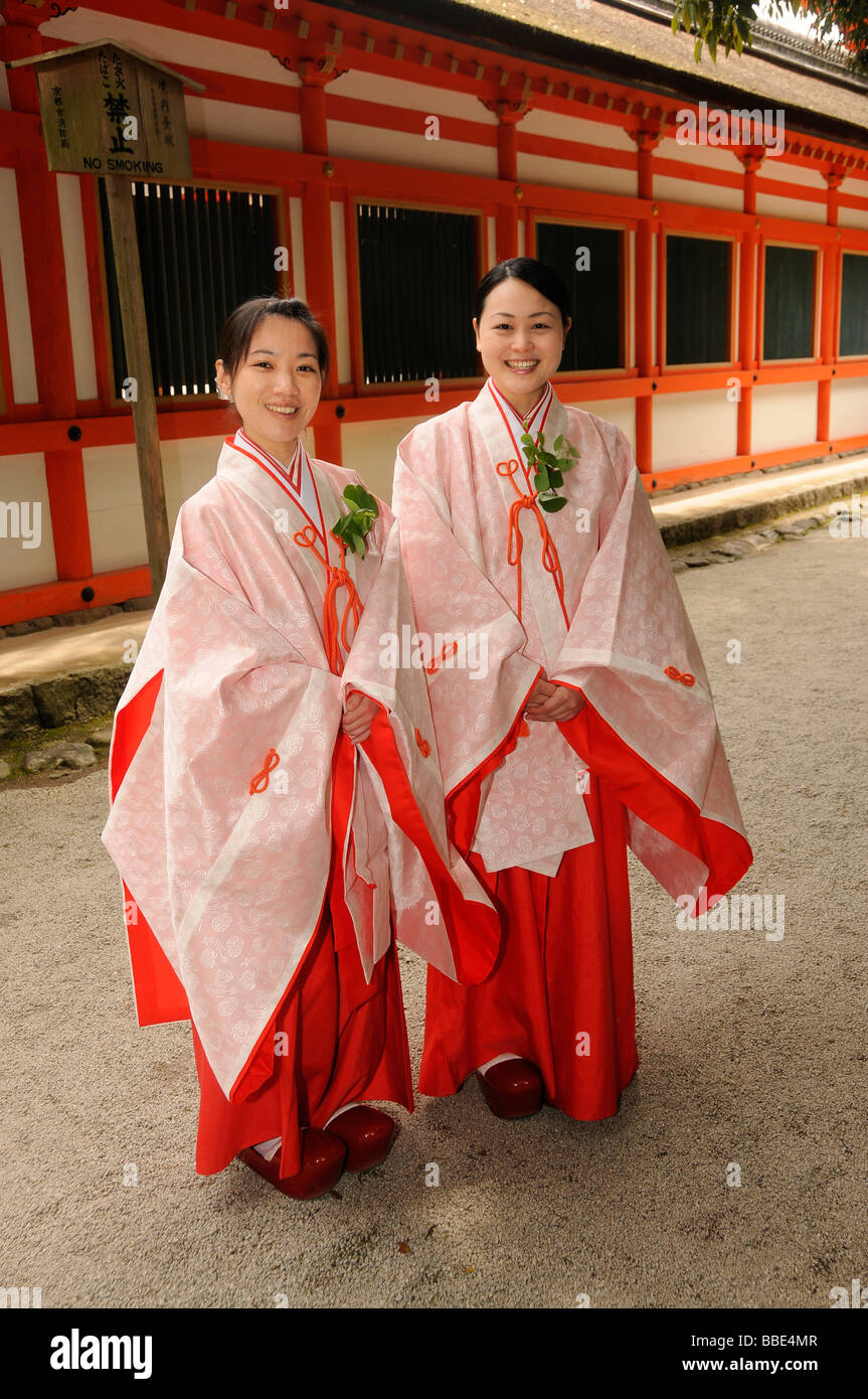Mikos, shrine maidens, wearing a kimono, and Aoi plant, Shimogamo ...
