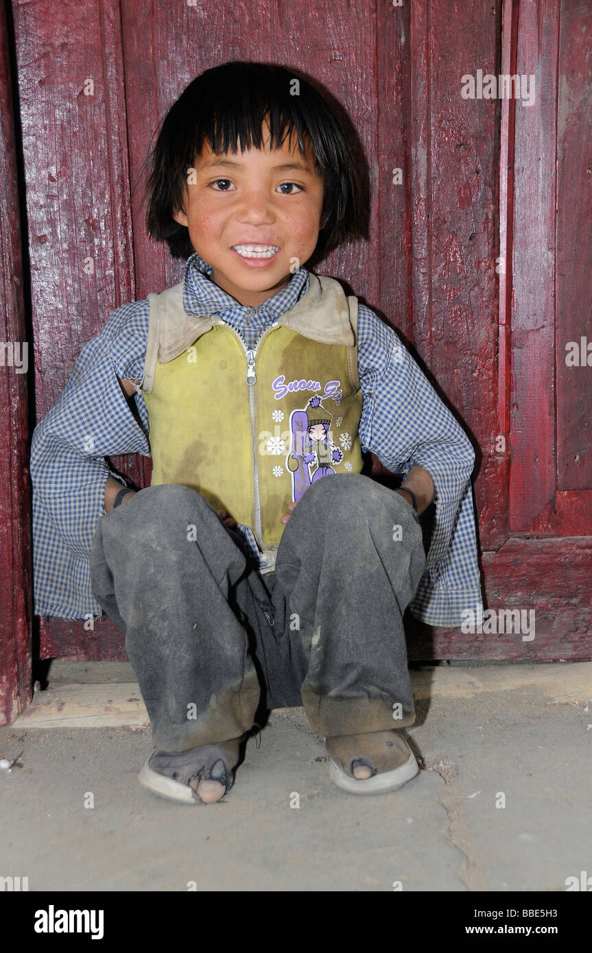 Poor primary schoolchild in front of the village school, Leh, Ladakh ...
