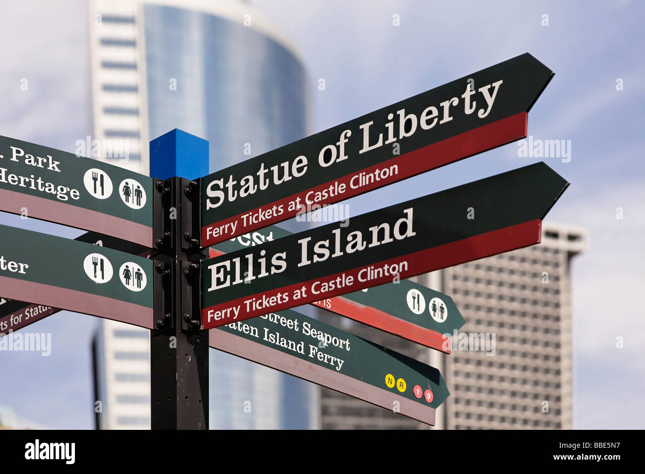 Directional signs to the Statue of Liberty and Ellis Island in Lower ...
