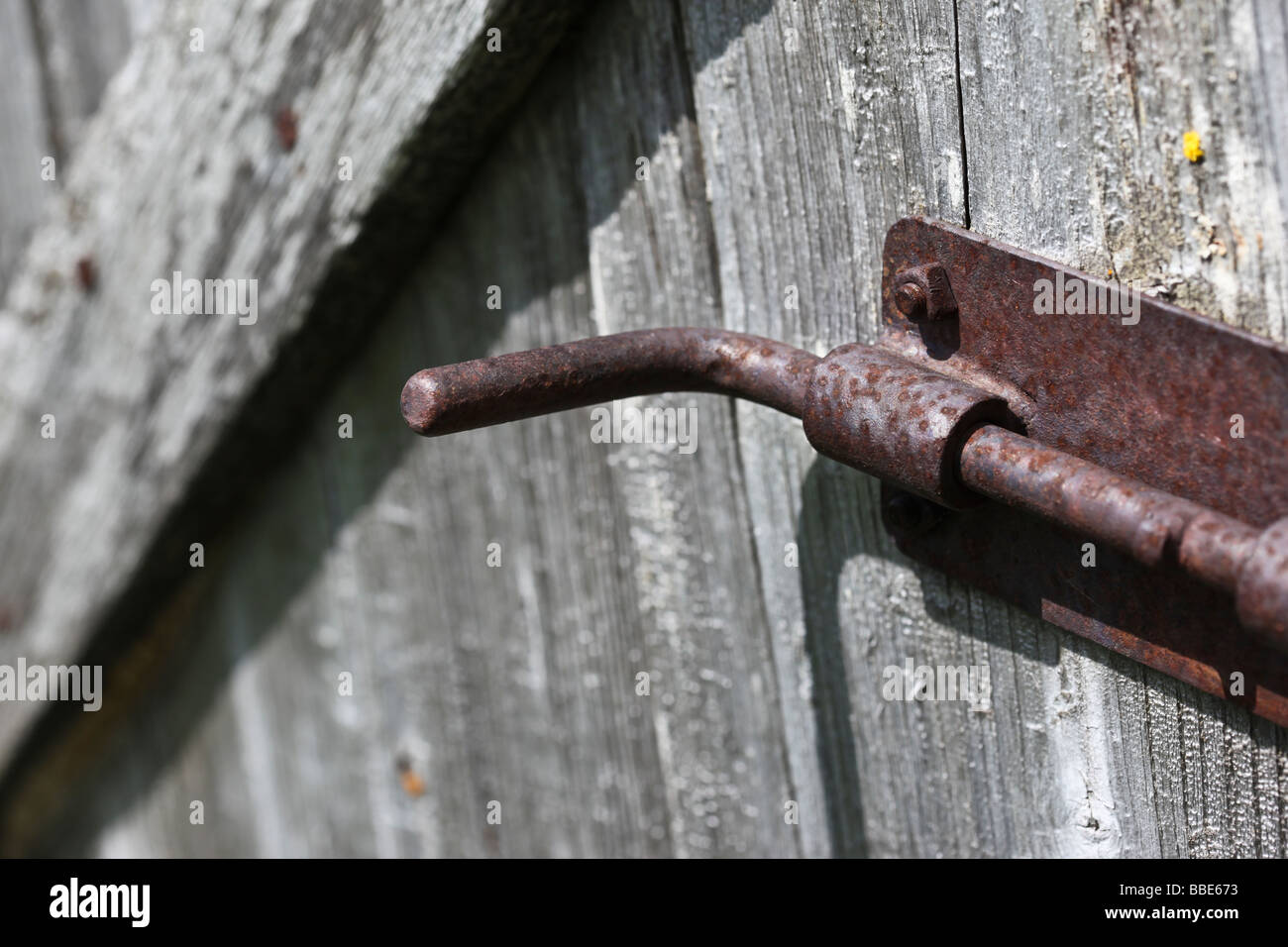 Rusty door bolt in old door latch Stock Photo - Alamy