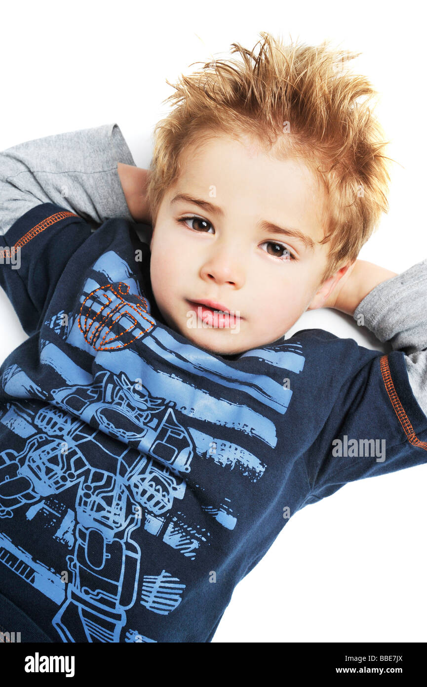 Good looking young boy with brown eyes posing on a white studio and ...
