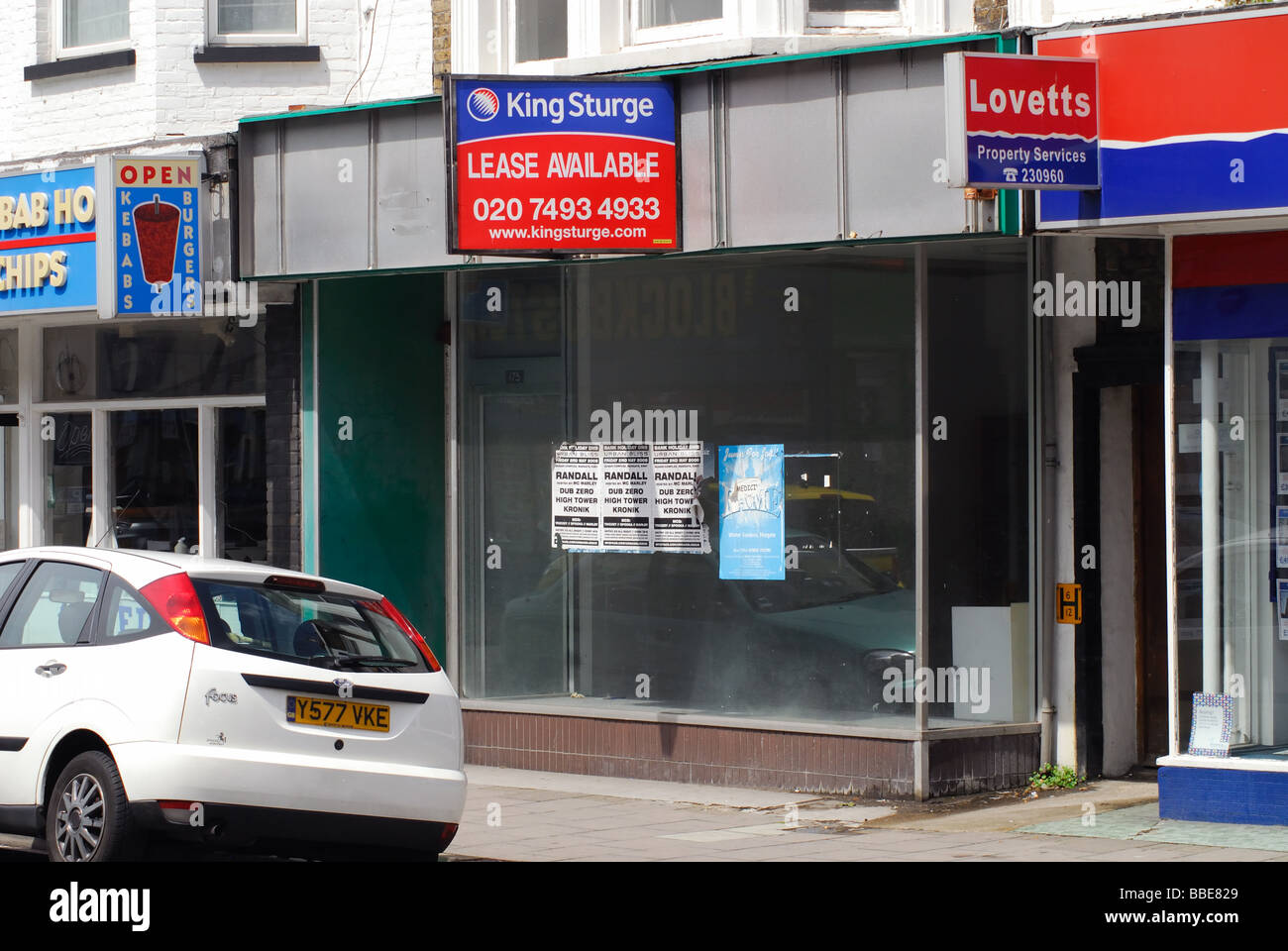 A Closed Down Shop with a lease available sign above its front window ...