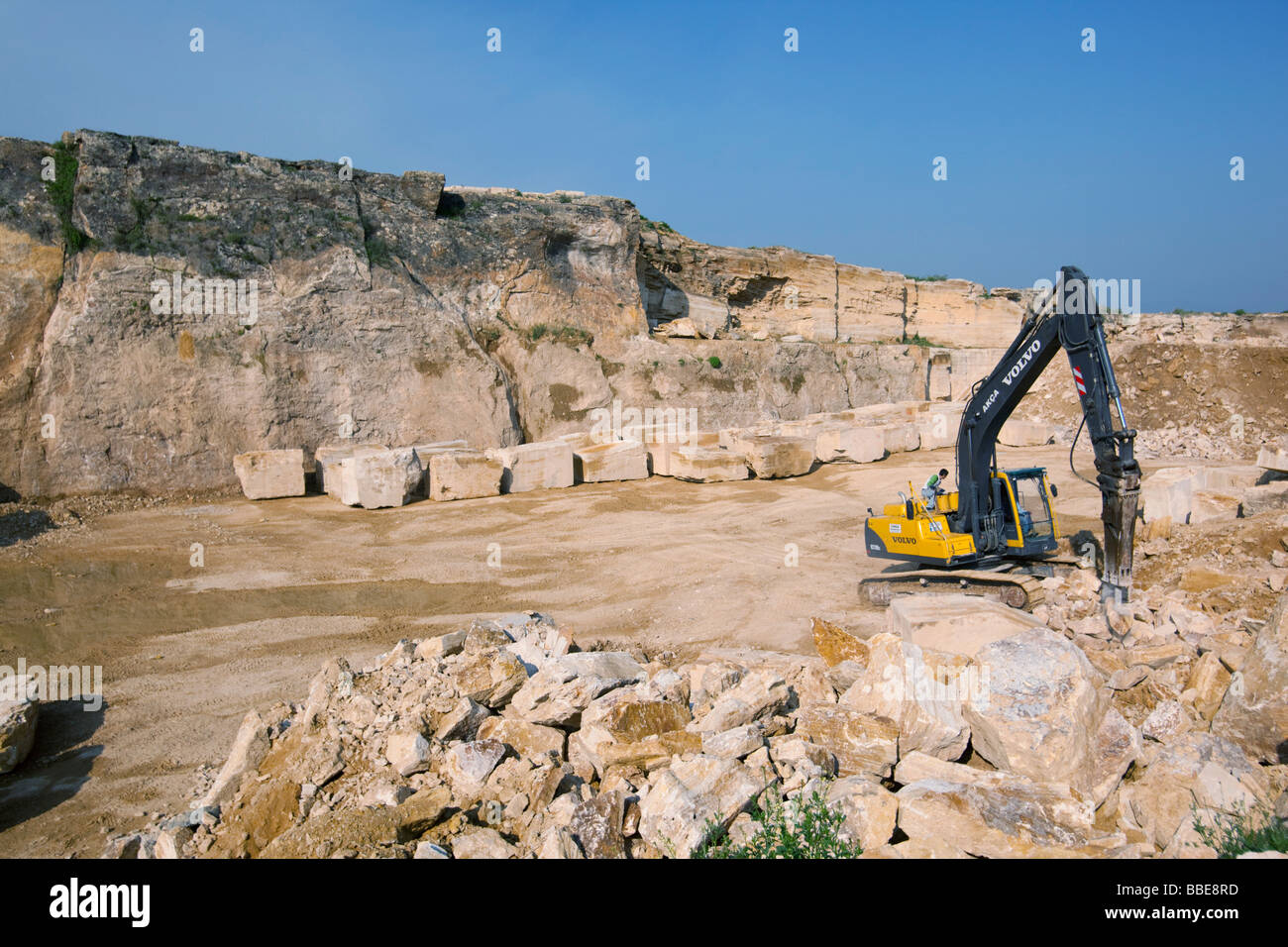 Power hammer chipping away for blocks of marble at an open pit mine in ...