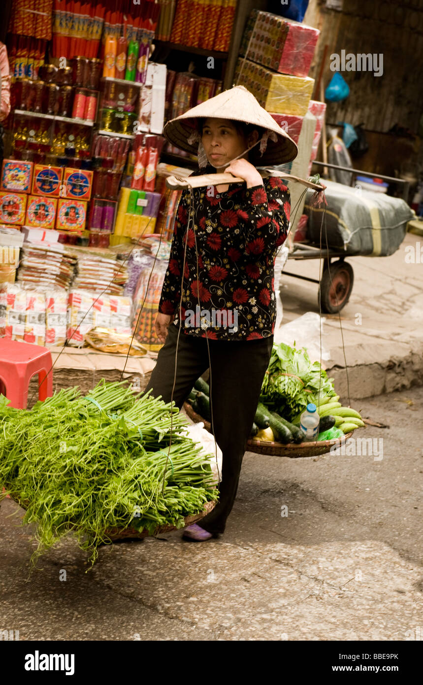 Street hawker carrying bamboo basket of vegetable to sell around old ...
