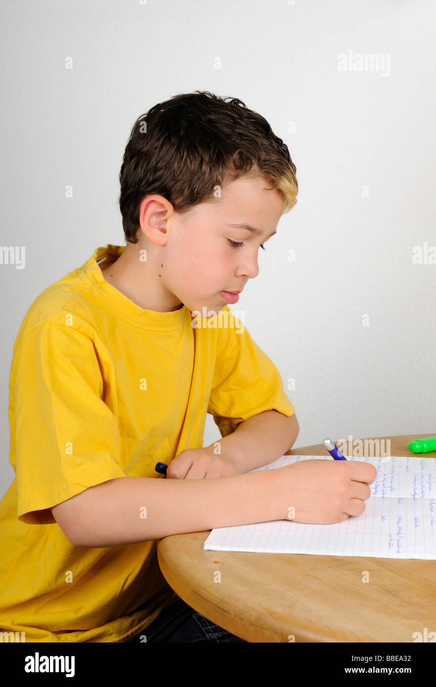 Boy doing homework for school Stock Photo - Alamy