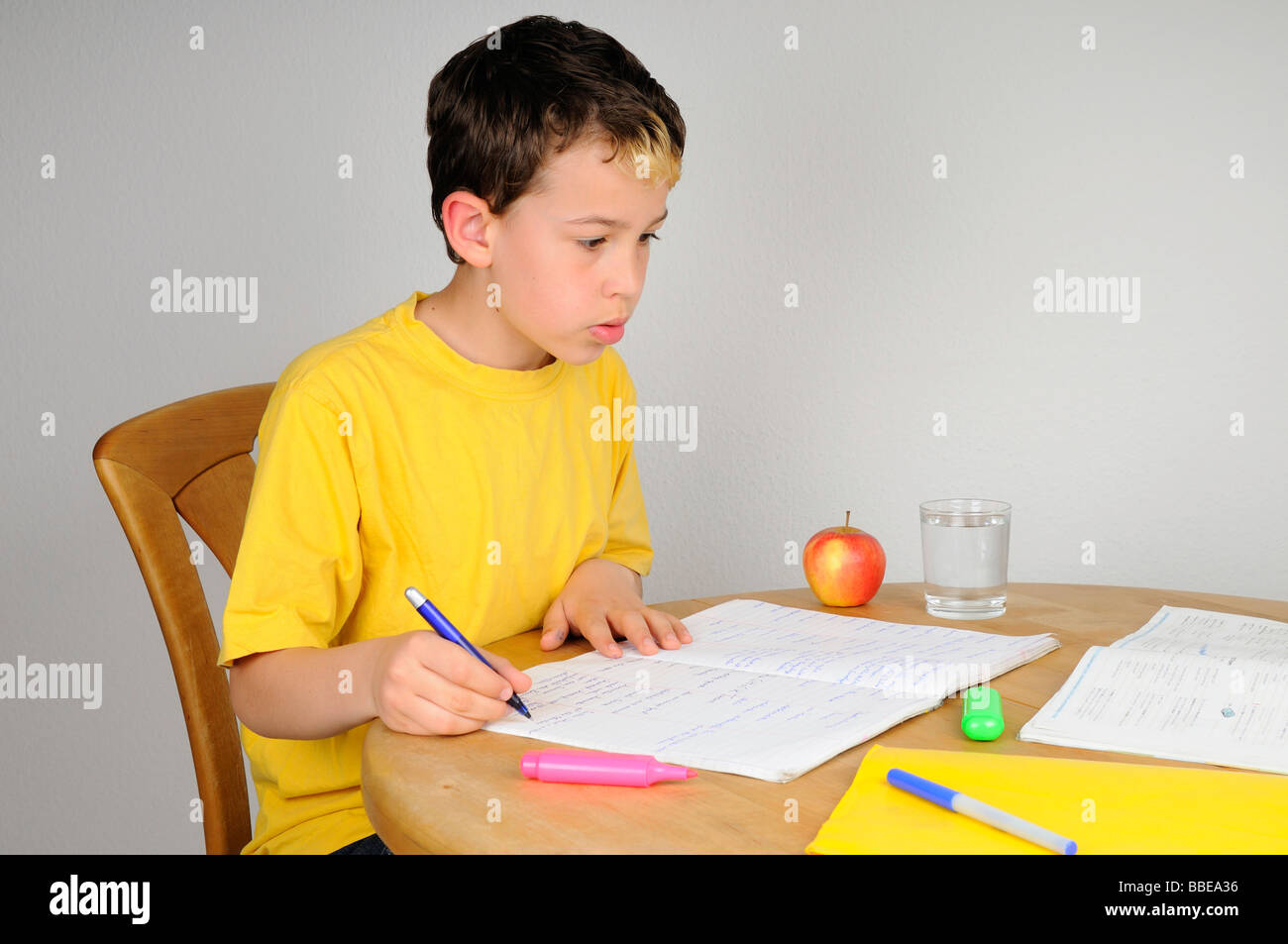 Boy doing homework for school Stock Photo - Alamy