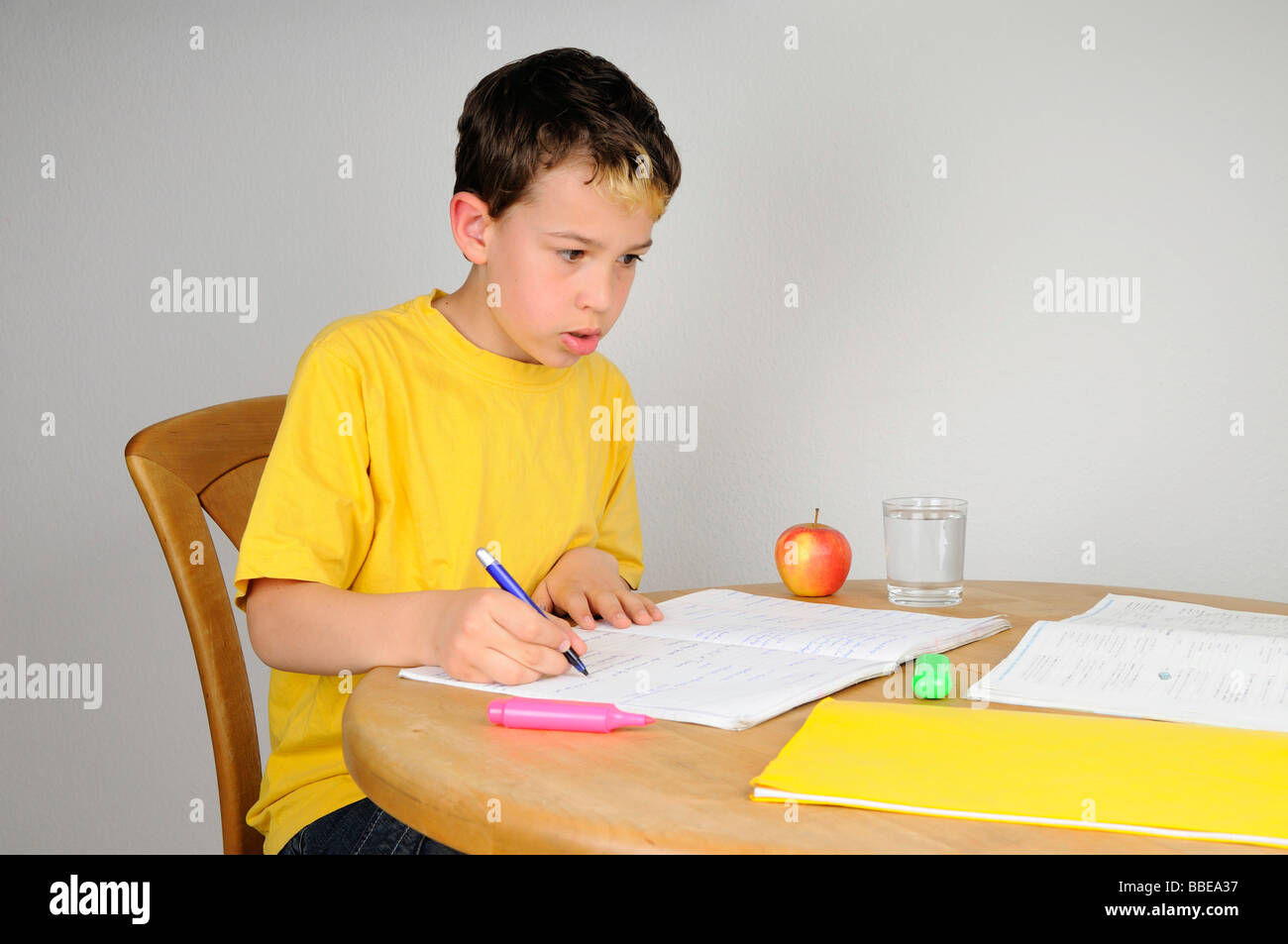 Boy doing homework for school Stock Photo - Alamy