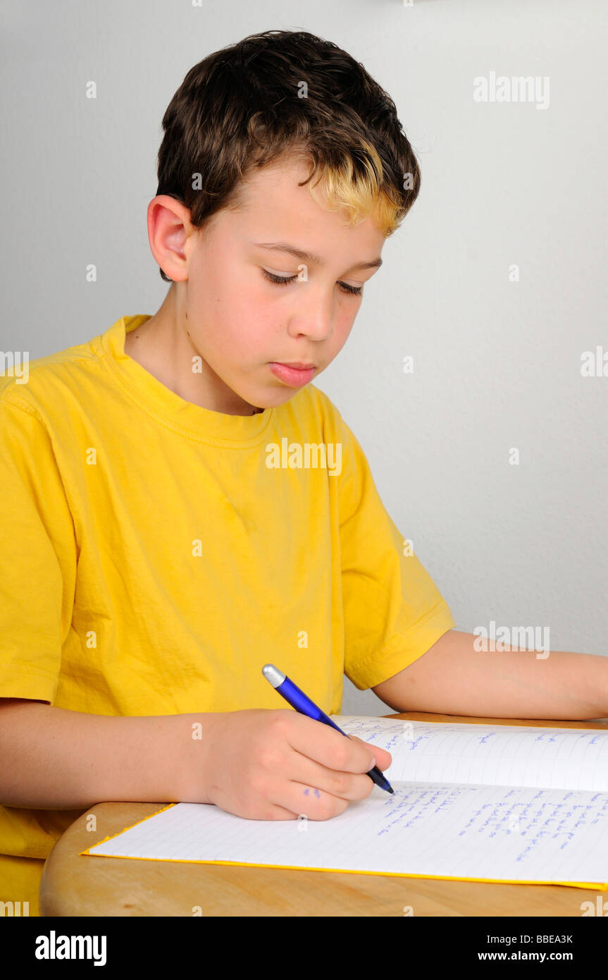 Boy doing homework for school Stock Photo - Alamy