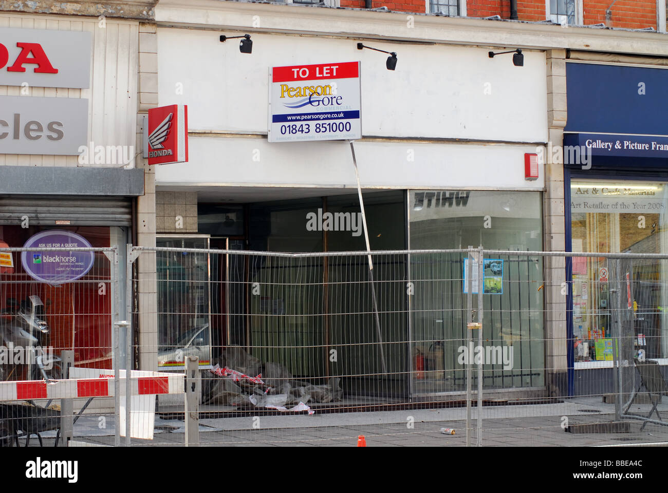 A Closed Down Shop with a to let sign above the entrance to the shop ...