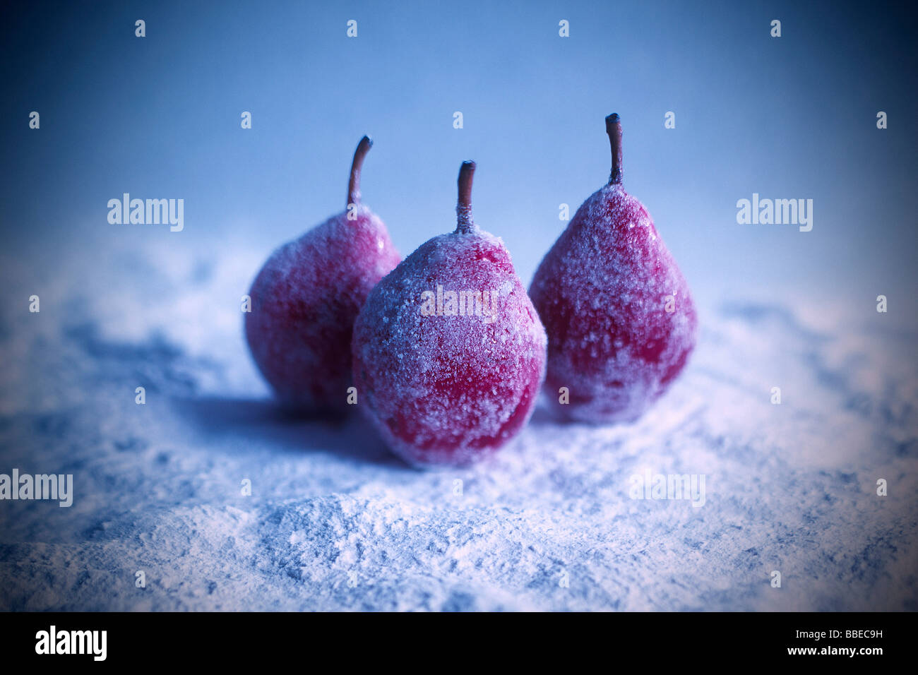 Three Red Candied Pears on Snowy Background Stock Photo - Alamy