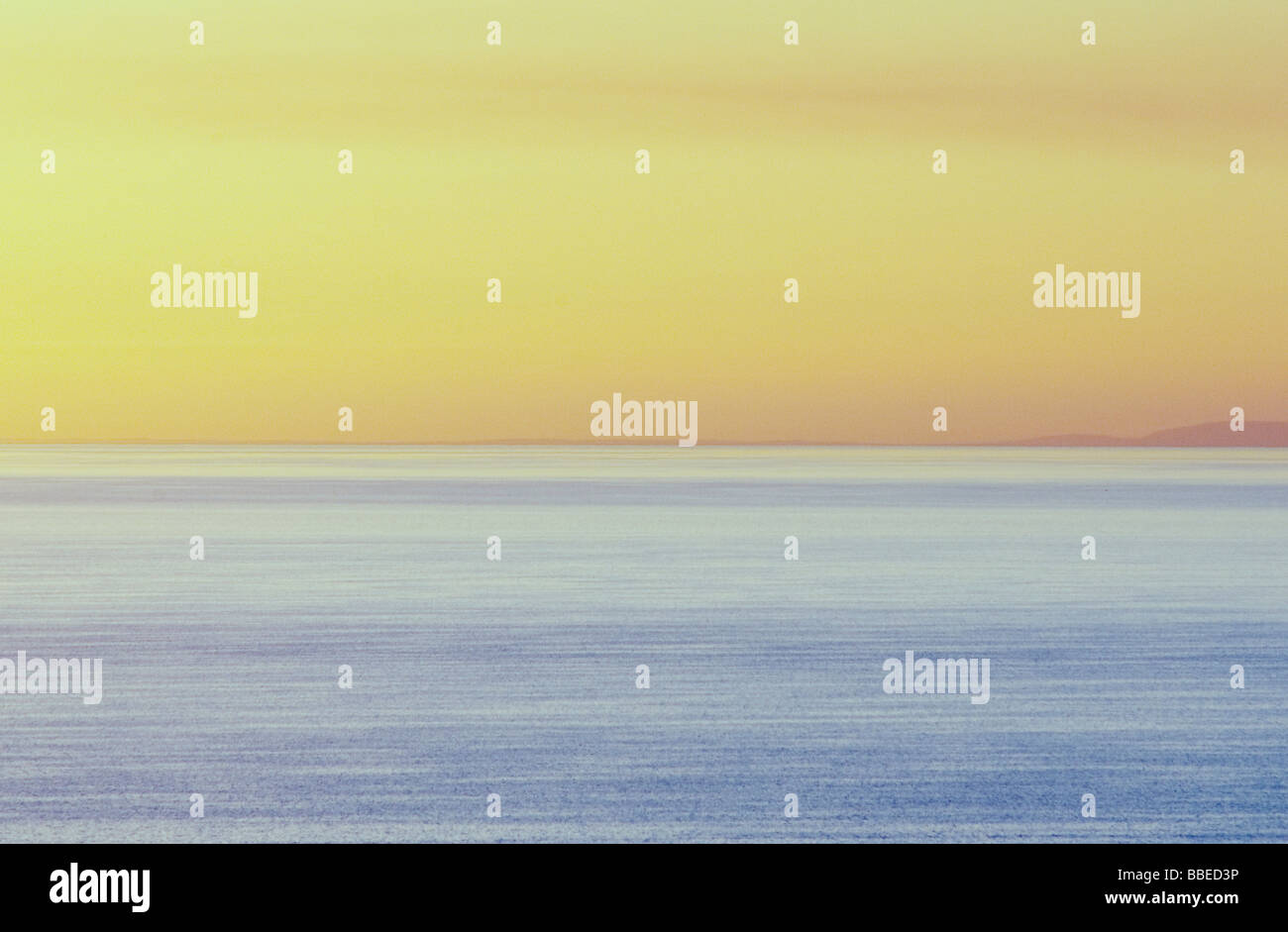 Sky and sea after sun has set looking watery Stock Photo - Alamy