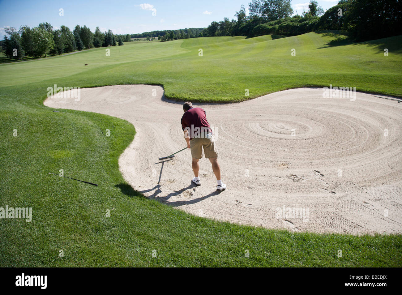 Man Maintaining Sand Trap, Burlington, Ontario, Canada Stock Photo - Alamy