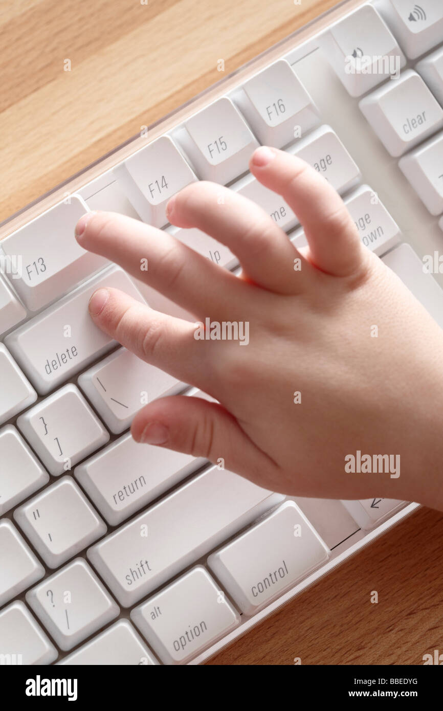 Child Pressing Delete Key on Computer Stock Photo - Alamy