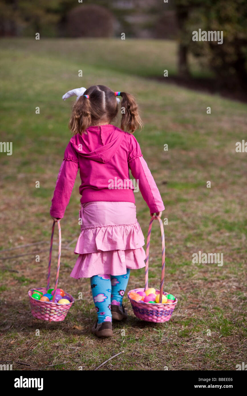 Young Girl Walking with Easter Baskets Stock Photo - Alamy
