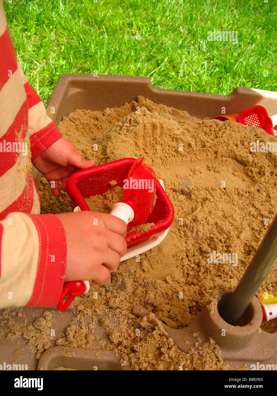 A Boy Plays in A Sandbox Stock Photo - Alamy