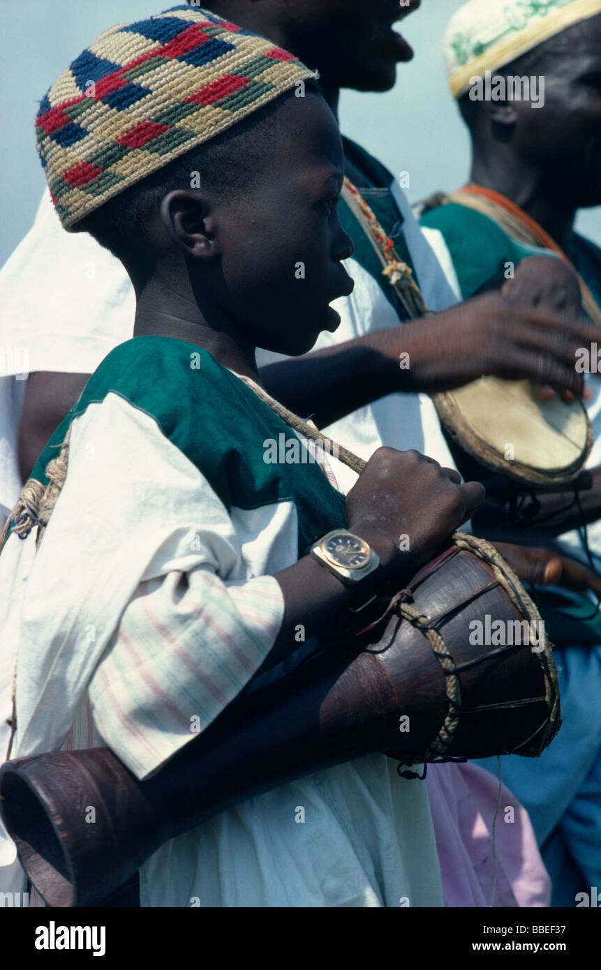 NIGERIA West Africa Music Child musician playing bongo drums Stock ...