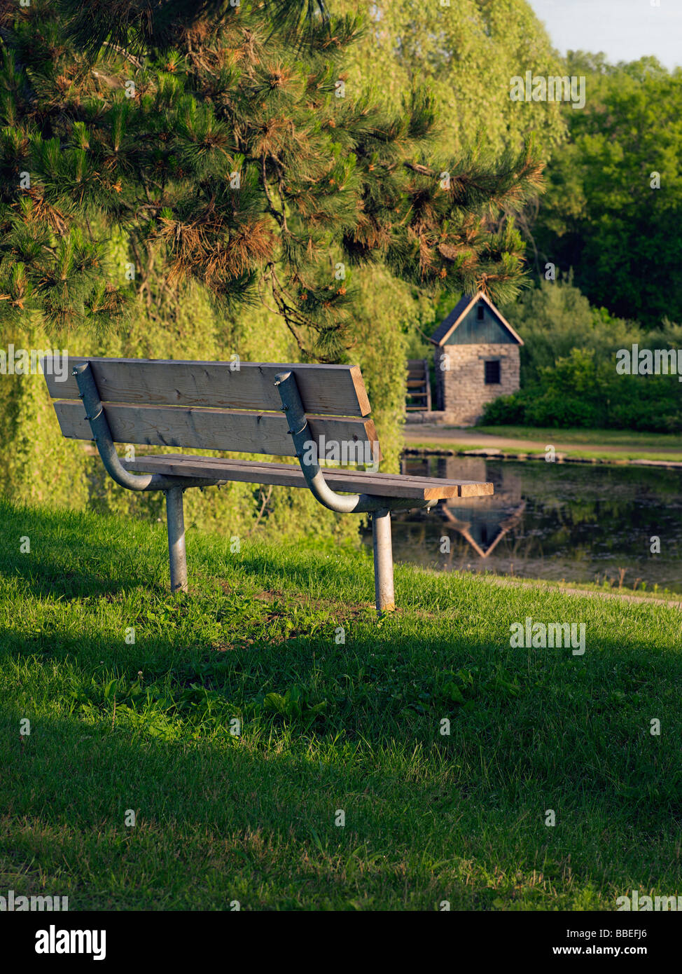 Bench by Pond and Mill Stock Photo - Alamy