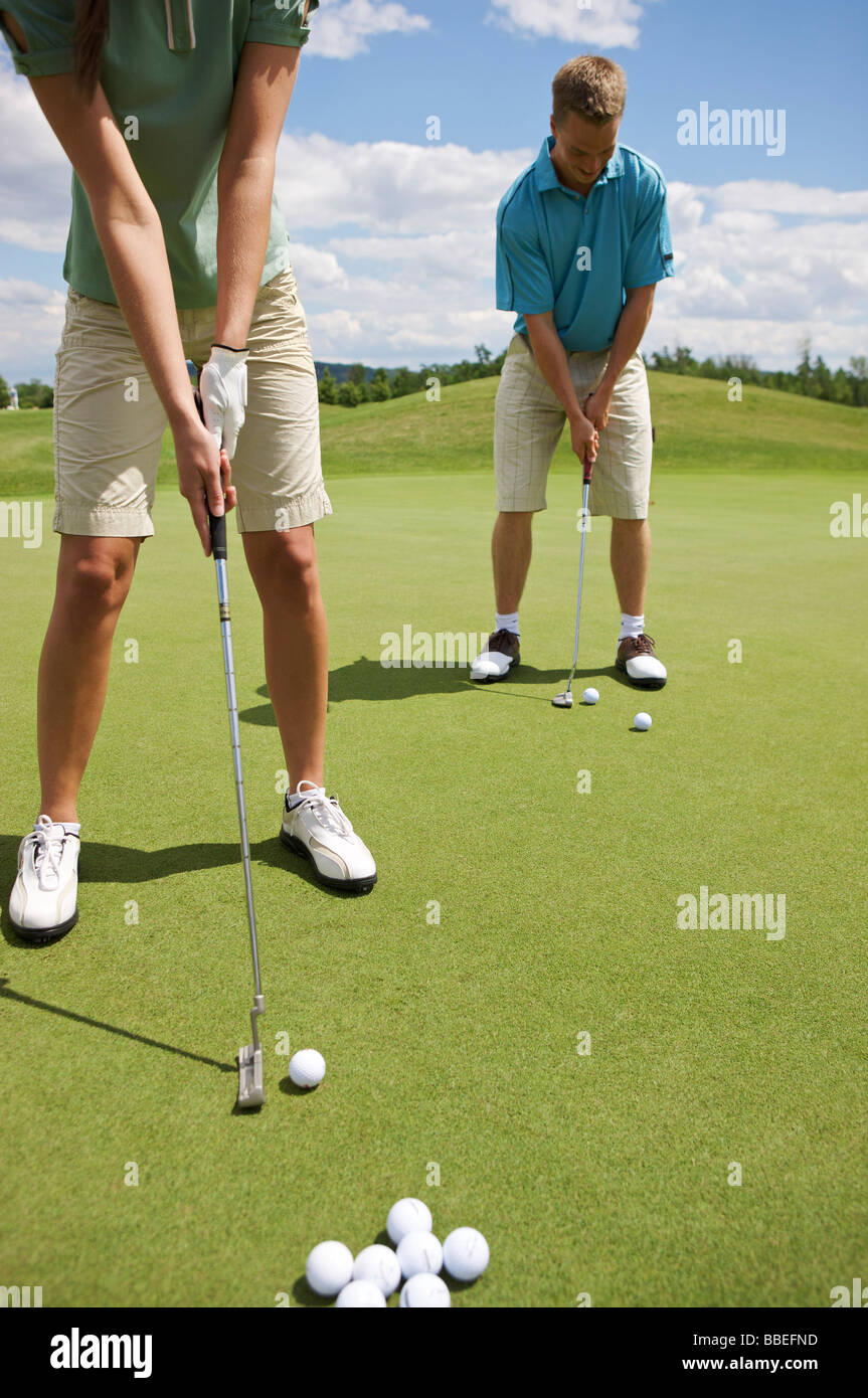 Couple Practicing Putting Stock Photo - Alamy
