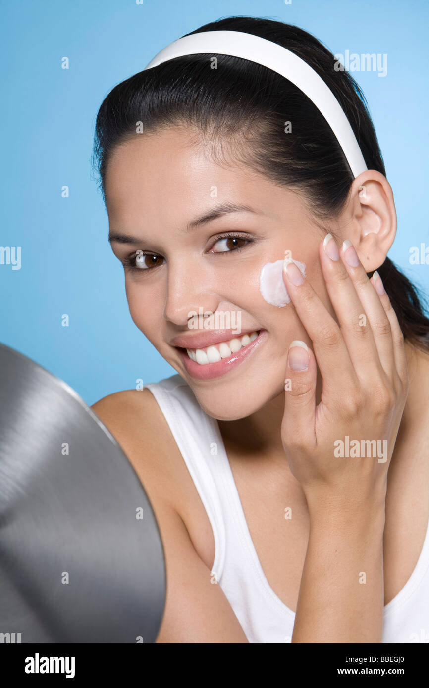 Portrait of Woman Applying Face Cream Stock Photo - Alamy