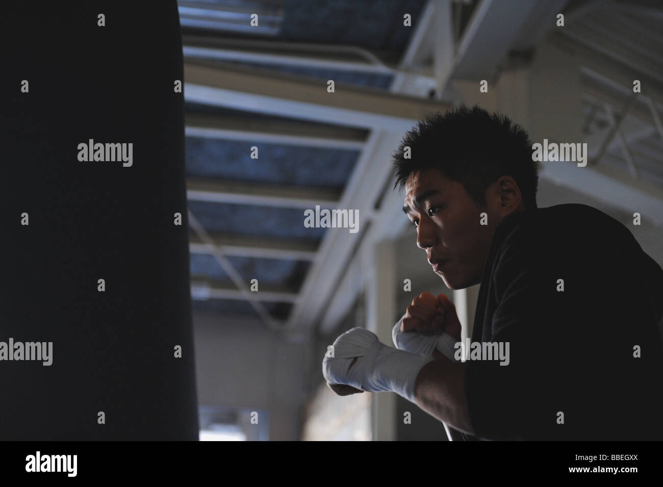Japanese boxer practicing with punching bag Stock Photo - Alamy