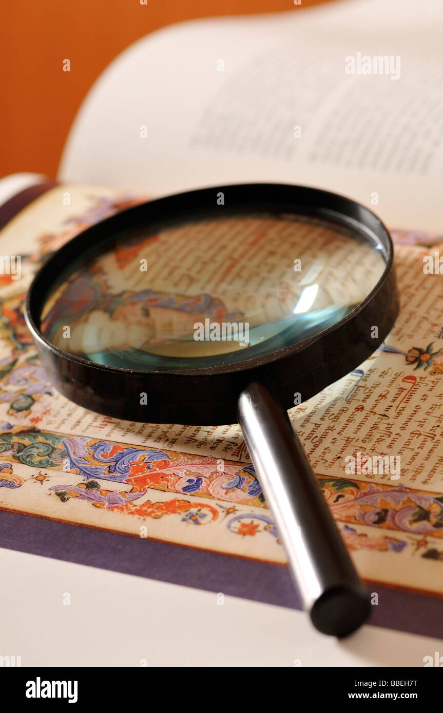Magnifying Glass on Page of Book Stock Photo - Alamy