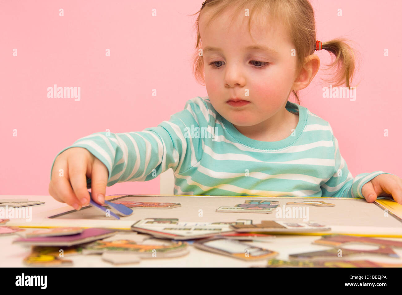 Little Girl Doing a Puzzle Stock Photo - Alamy
