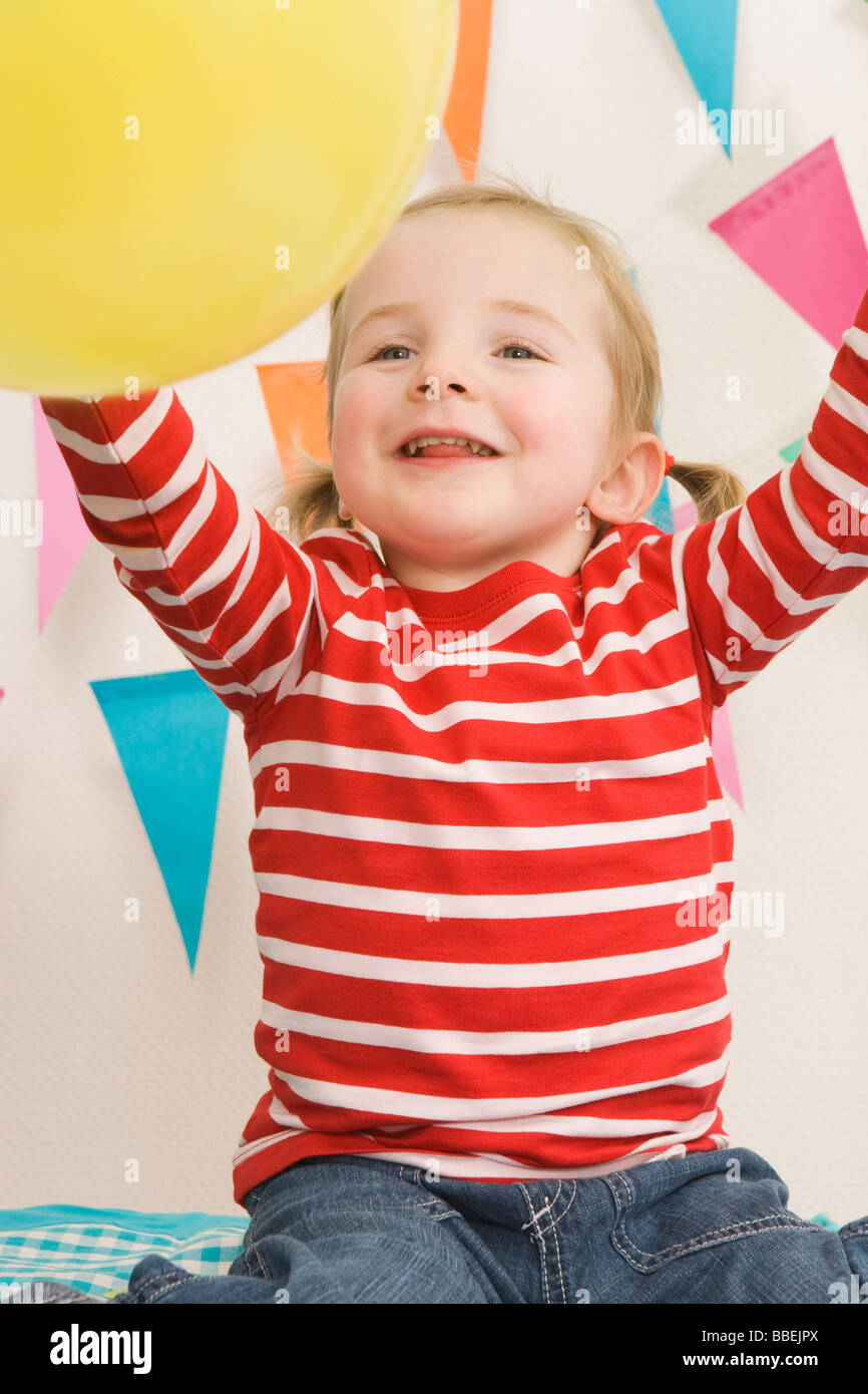 Little Girl Playing With a Balloon at a Birthday Party Stock Photo - Alamy