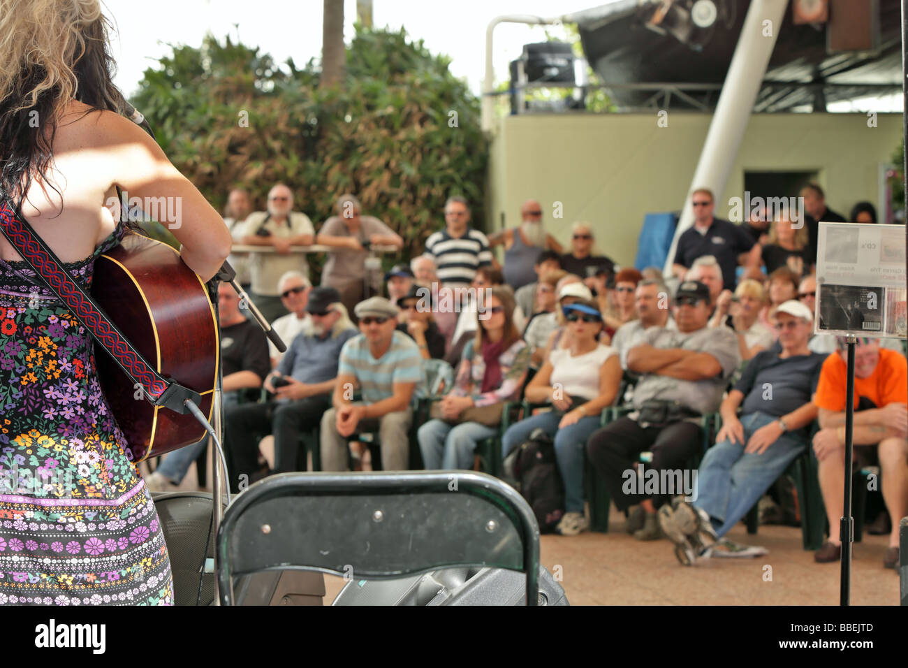 Female blues playing guitar and singing to crowd focus on singer Stock ...