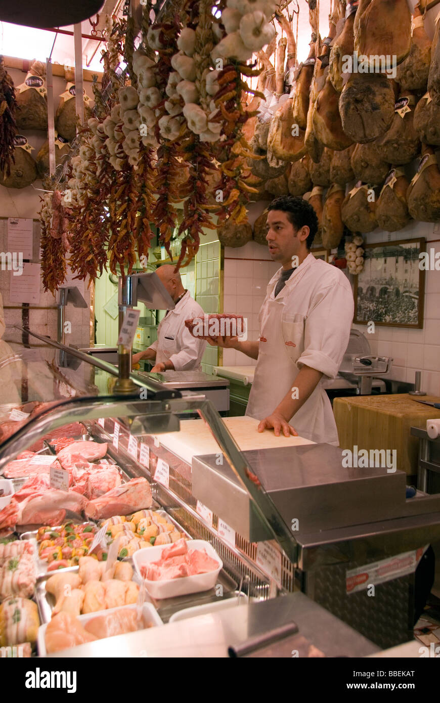 A butcher selling meat at the counter in one of Italy's finest butchers ...