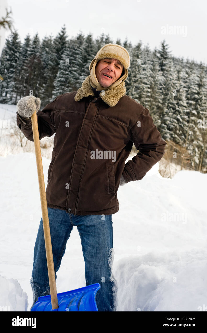 Man Suffering Back Pain While Shoveling Snow, Hof bei Salzburg ...