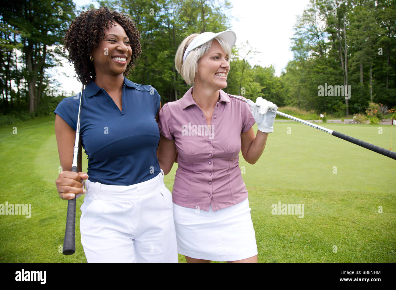 Women Standing on Golf Course Stock Photo - Alamy