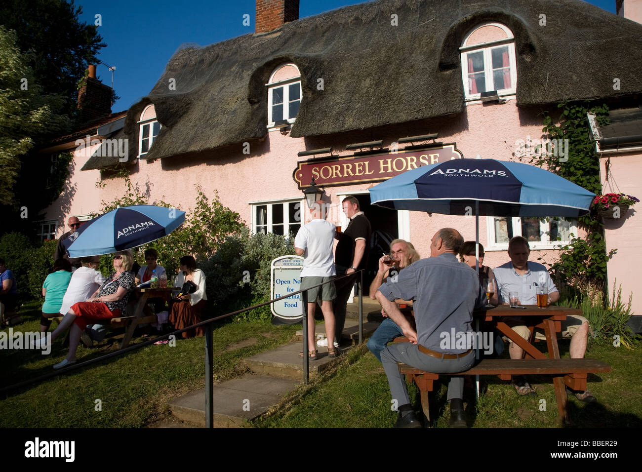 People sitting outside English country pub in summer Stock Photo - Alamy