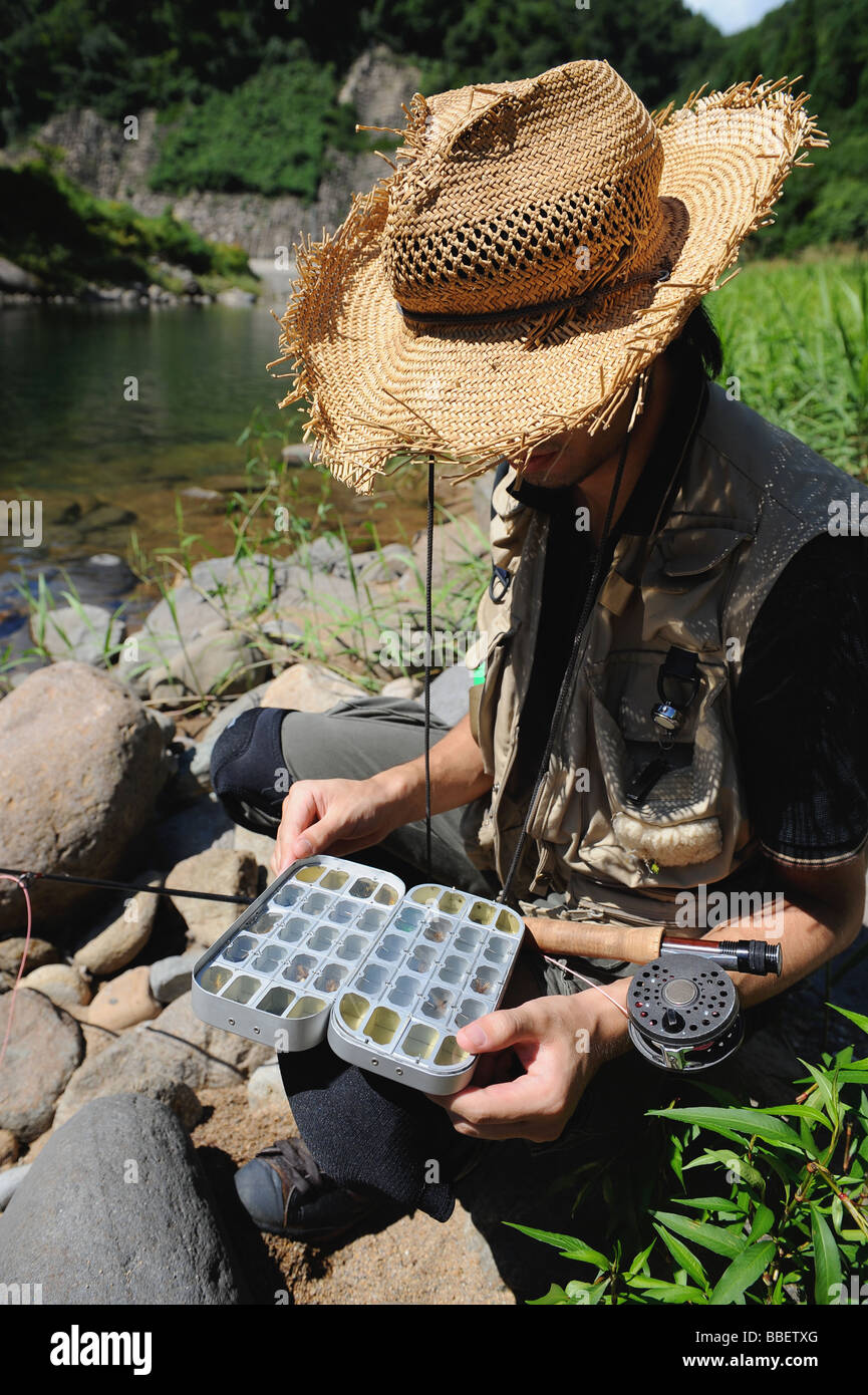 Man with straw hat fishing Stock Photo - Alamy