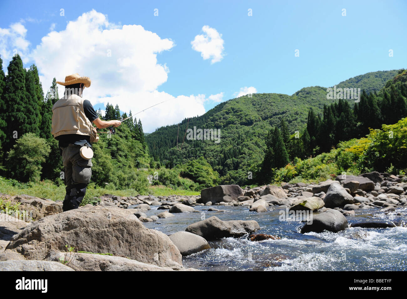 Man with straw hat fishing Stock Photo - Alamy