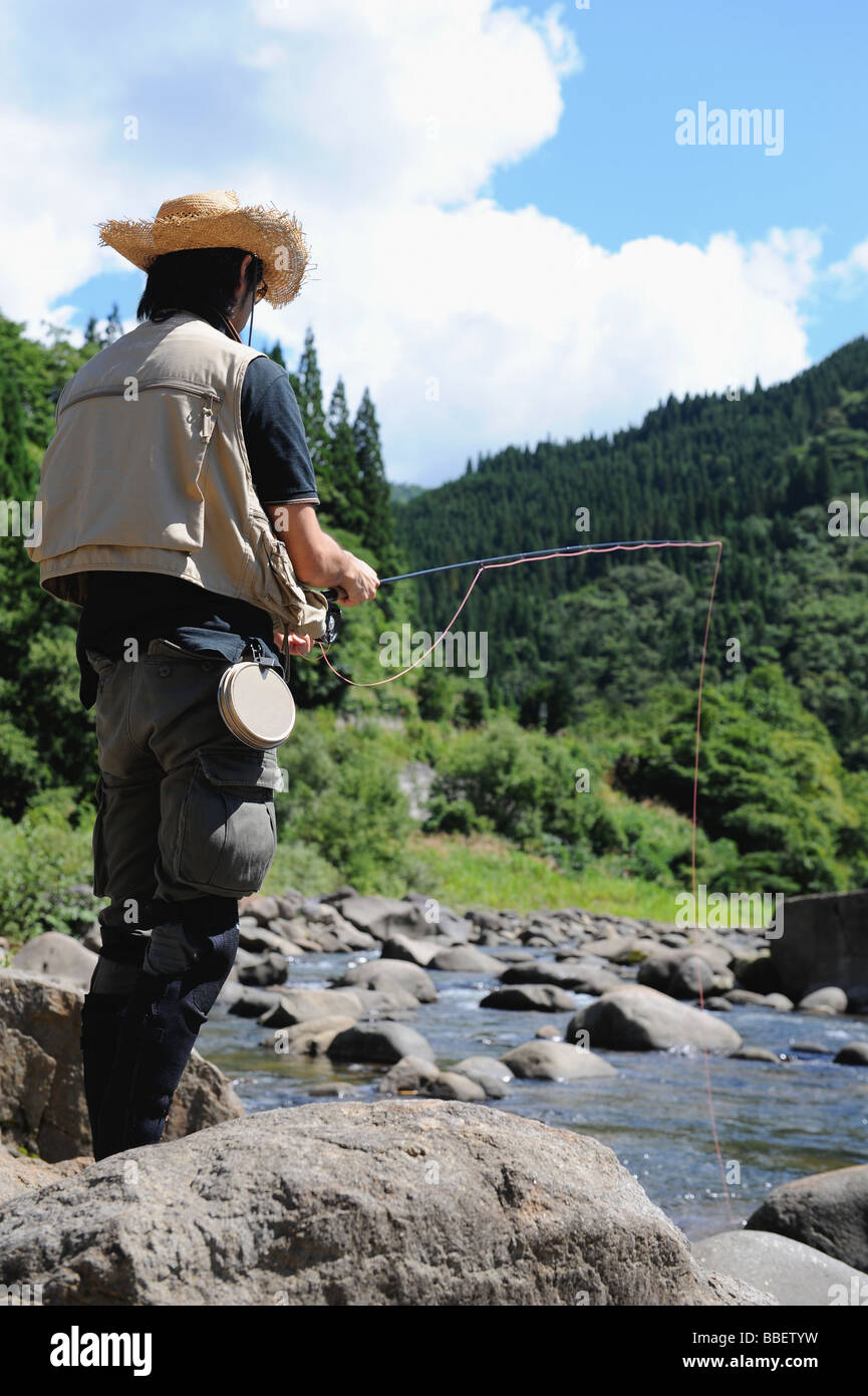 Man with straw hat fishing Stock Photo - Alamy