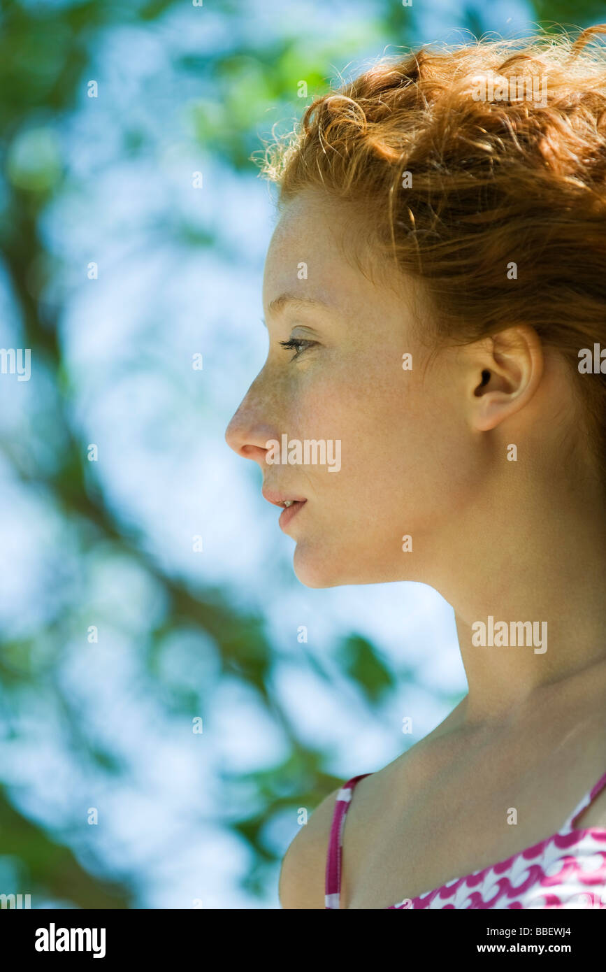 Young red haired woman in profile, portrait Stock Photo - Alamy