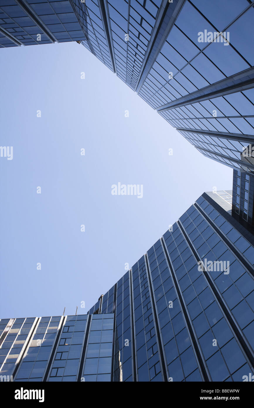 High rise office buildings against blue sky, viewed from below, cropped ...