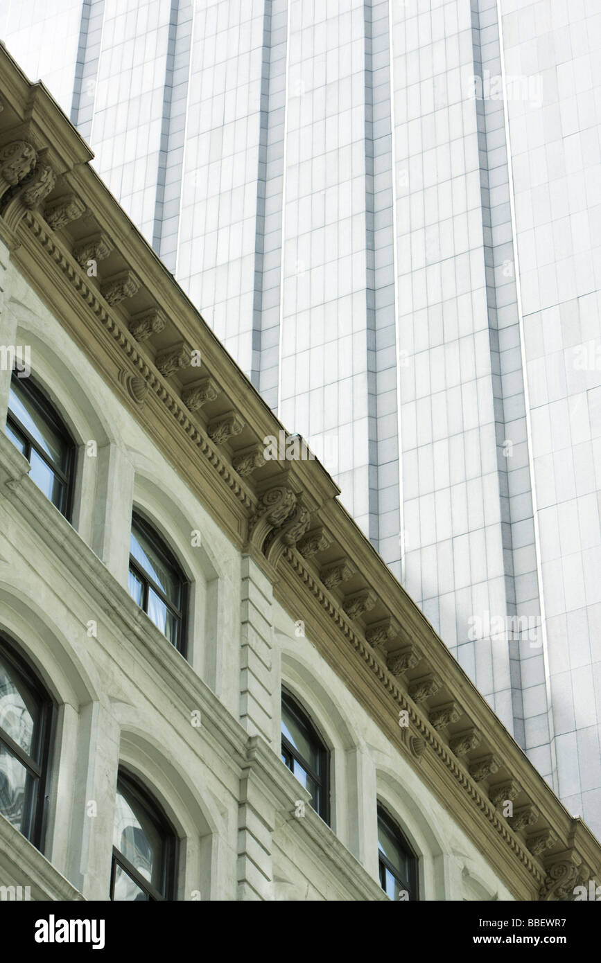 Facade of neoclassical building, modern skyscraper towering above, low ...
