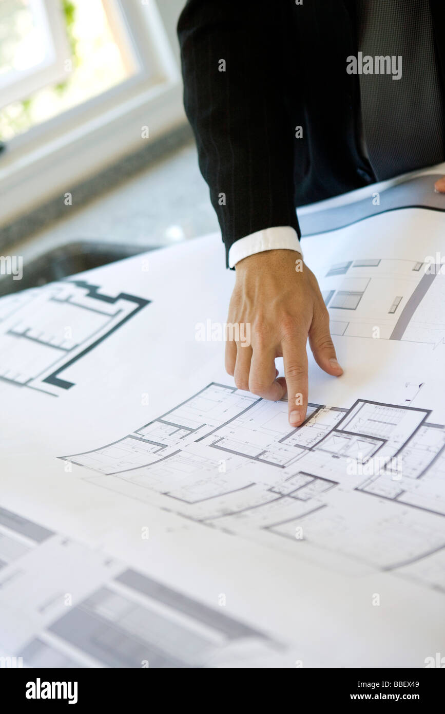 Man pointing at area on blueprint, close-up Stock Photo - Alamy