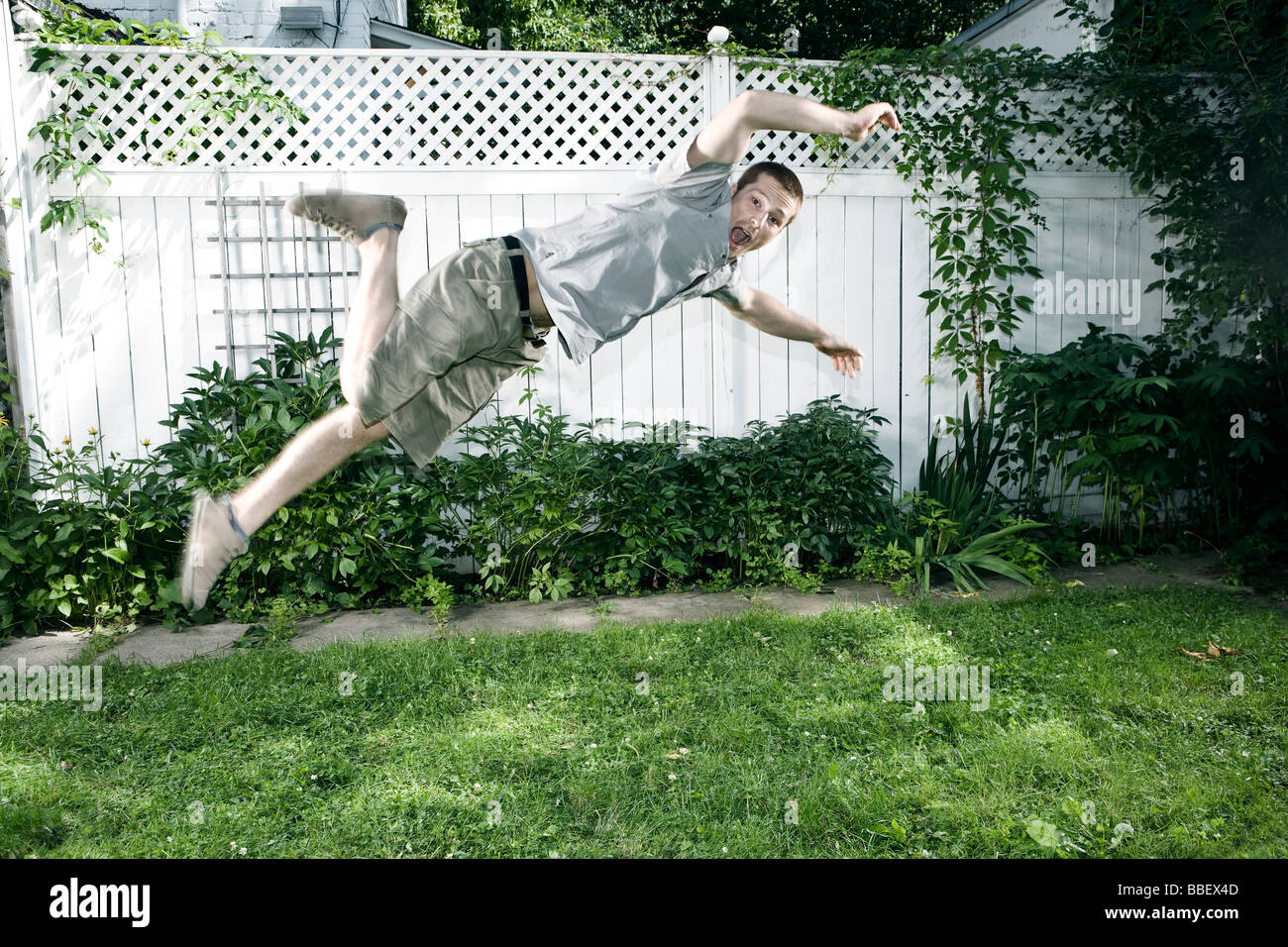 Man jumping in a backyard, Montreal, Quebec Stock Photo - Alamy