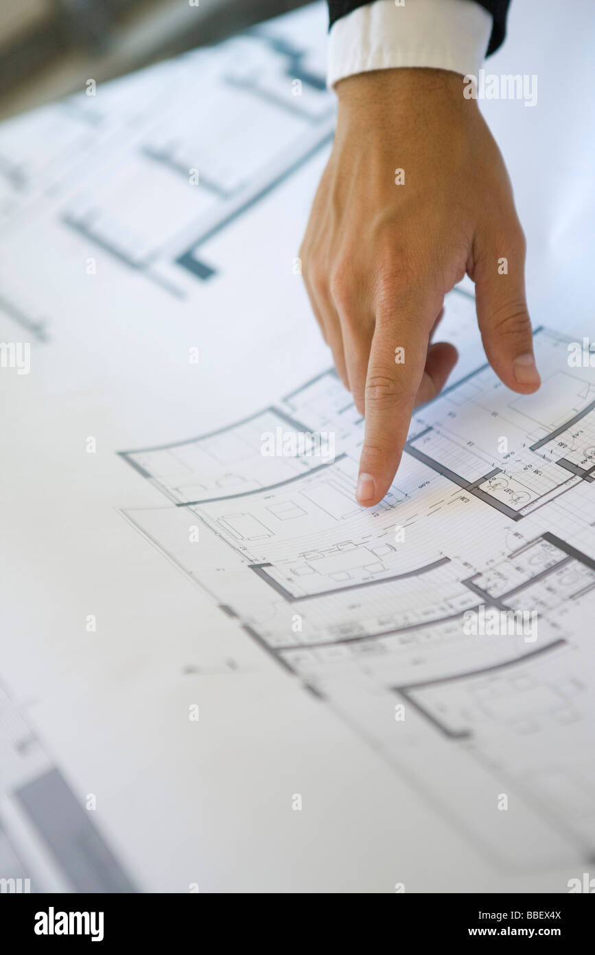 Hand pointing at area on blueprint, close-up Stock Photo - Alamy