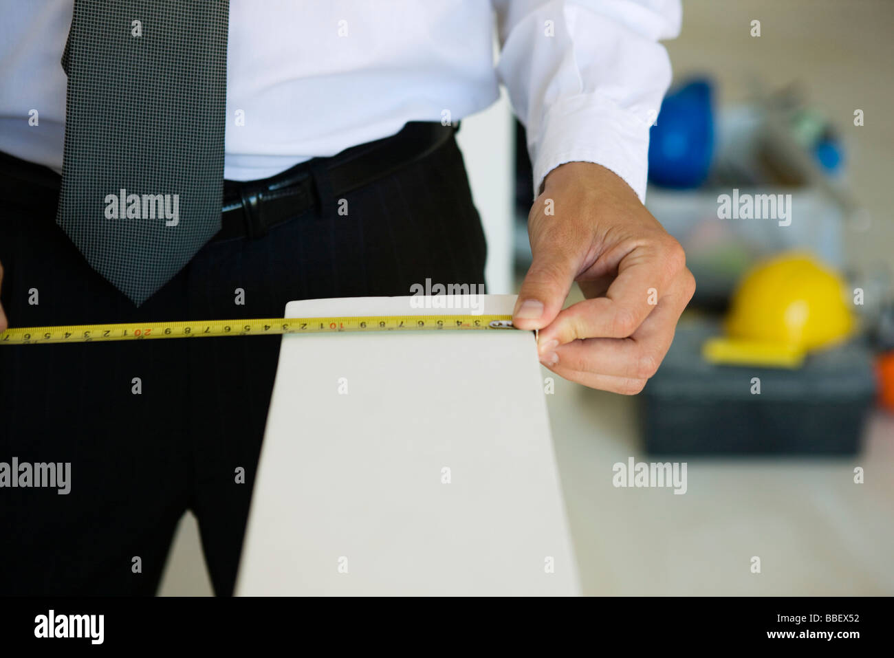 Well-dressed person measuring ledge width, close-up Stock Photo - Alamy