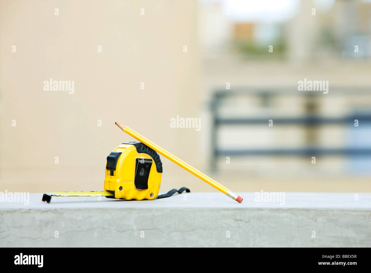 Measuring tape with pencil on ledge Stock Photo - Alamy
