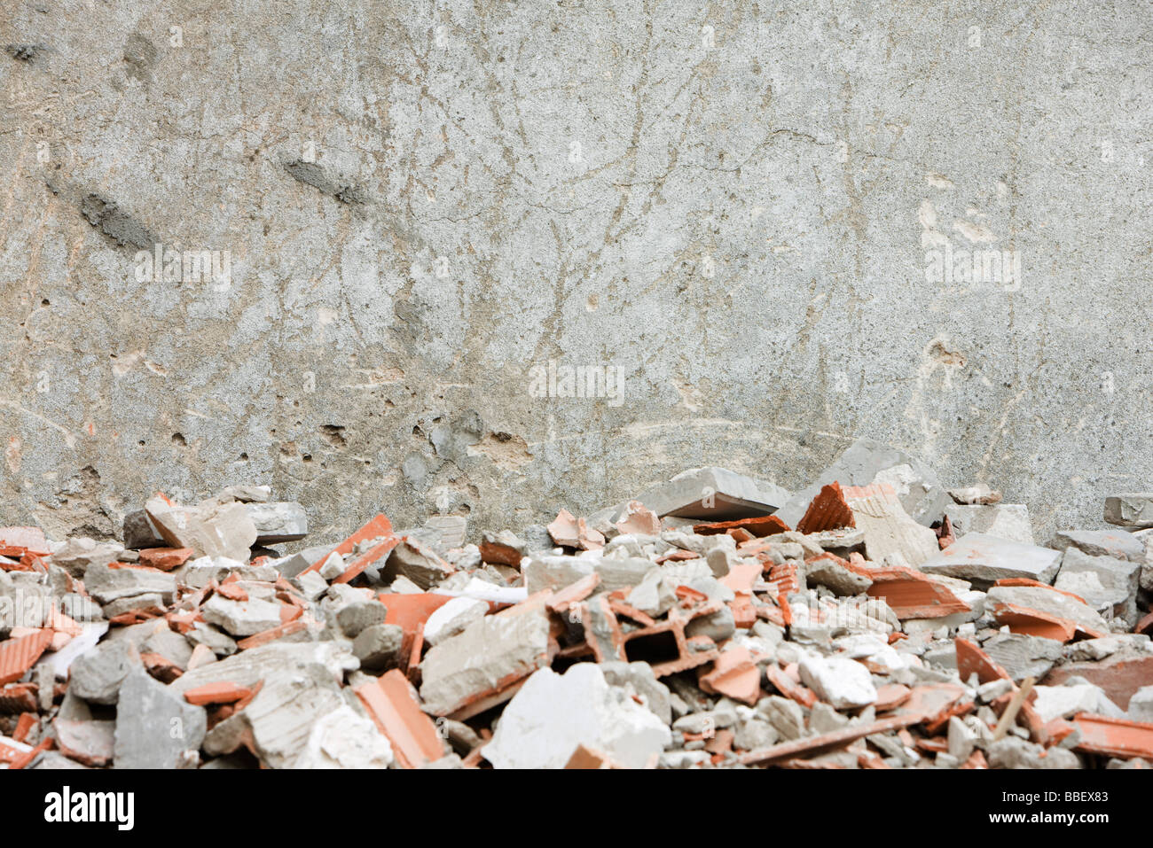 Construction rubble, broken bricks, pieces of concrete against wall ...
