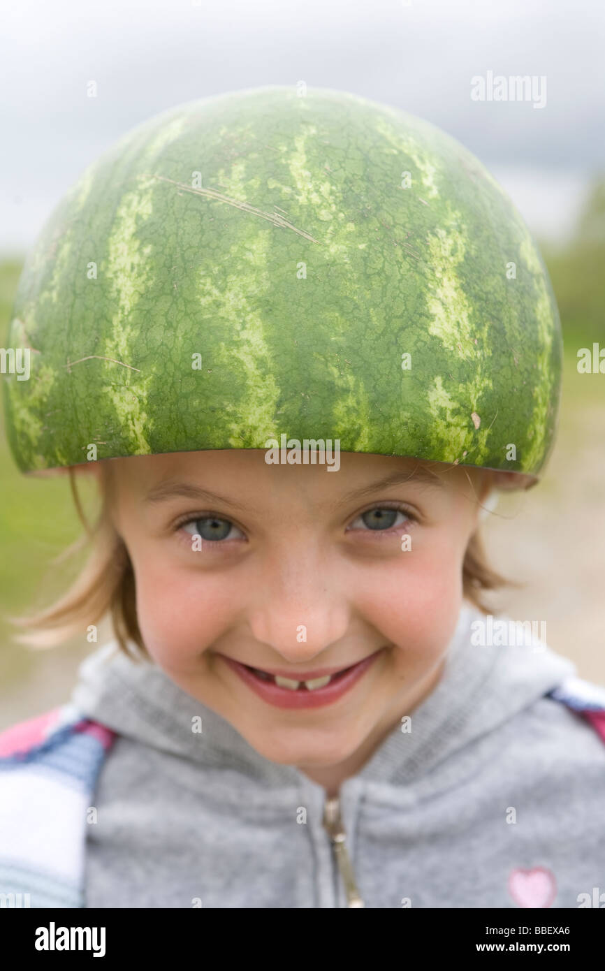 Girl with a helmet made from a watermelon on her head Stock Photo - Alamy