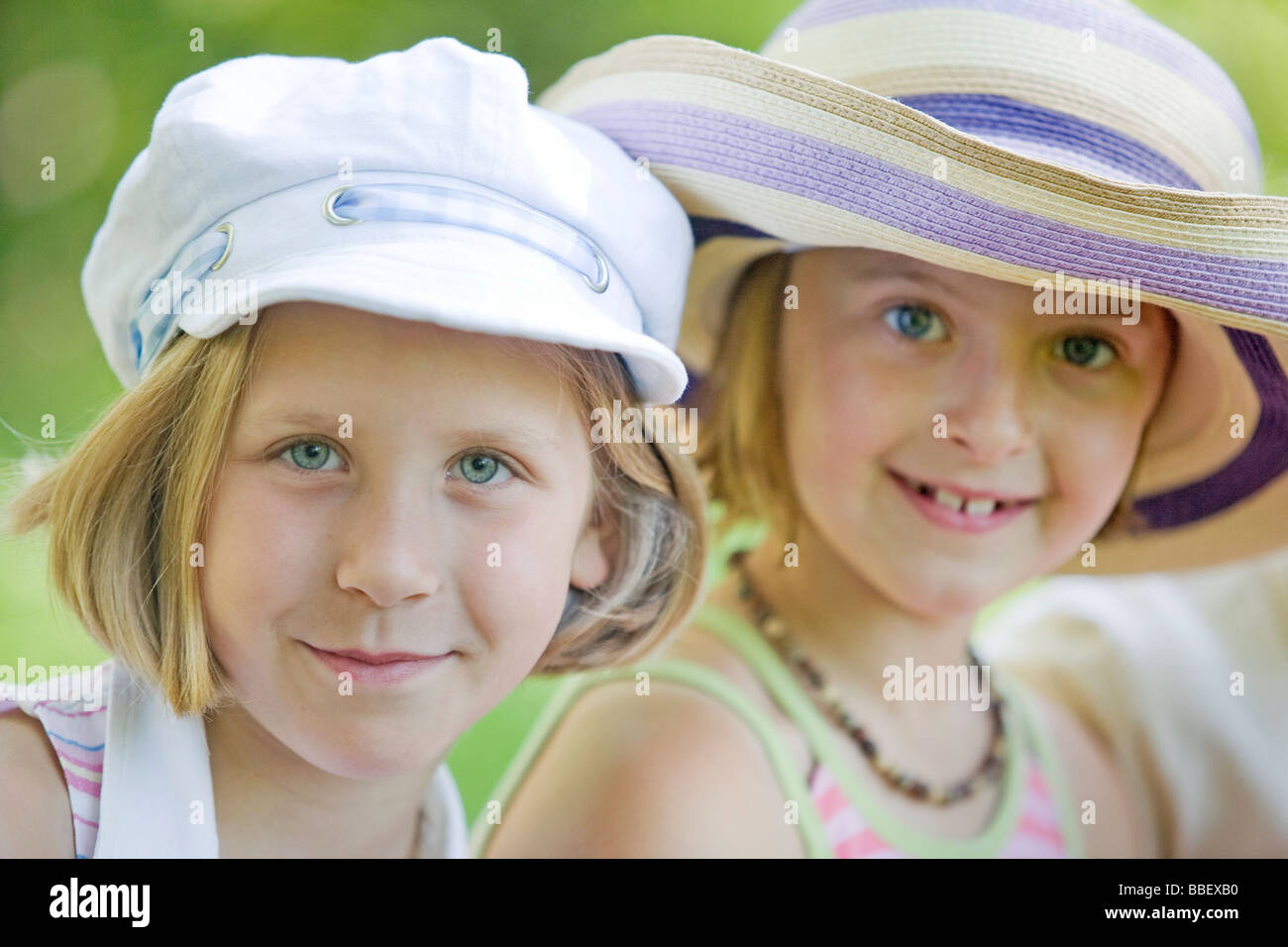 Portrait of two girls wearing hats Stock Photo - Alamy