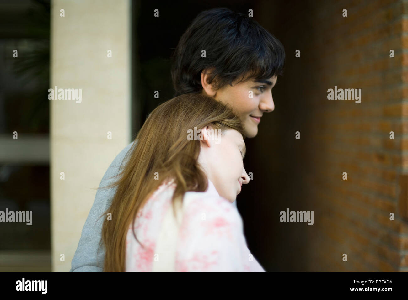 Young woman leaning head on boyfriend's shoulder, side view Stock Photo ...