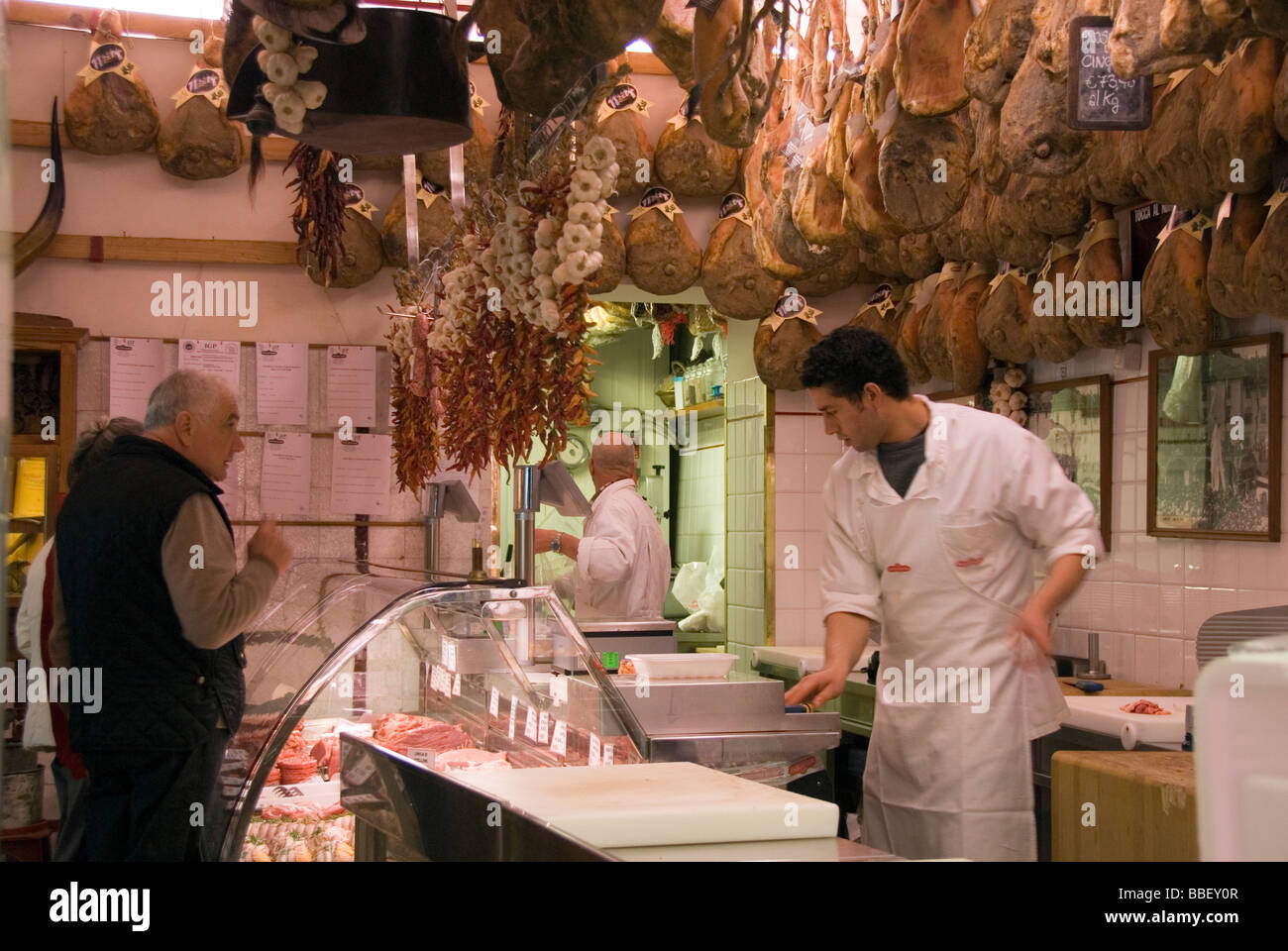 A butcher selling meat at the counter in one of Italy's finest butchers ...