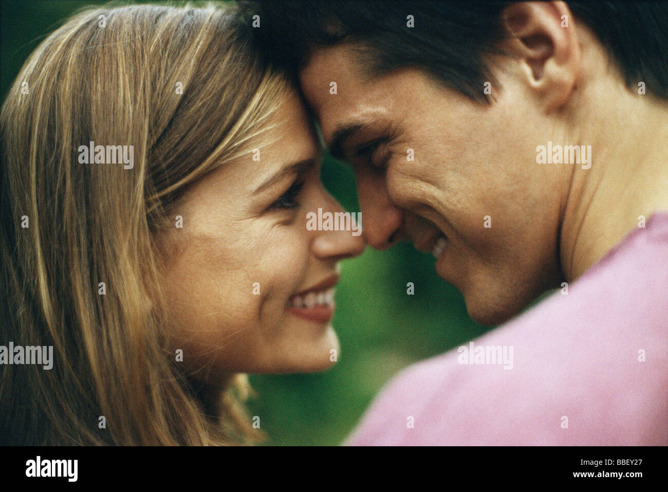 Couple face to face, touching noses and smiling at each other Stock ...